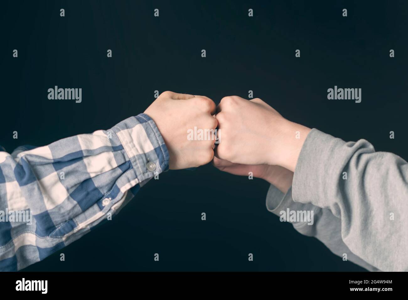 Fist bump or Knuckle bump between two friends Stock Photo - Alamy