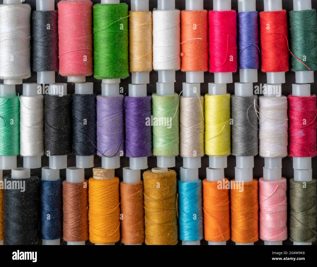 bunch of colorful sew threads lay on dark background isolated Stock ...