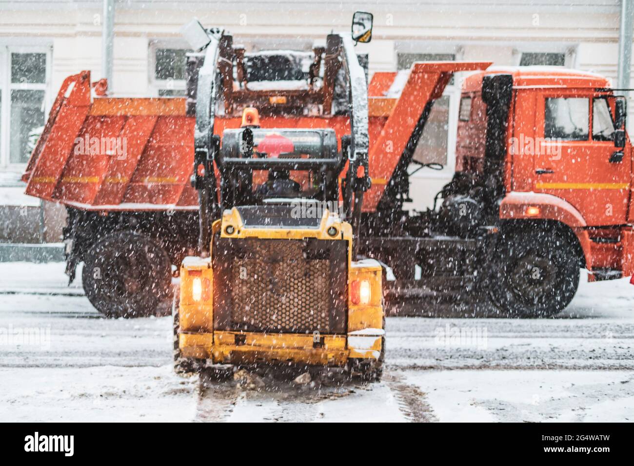 snow cleaning machine work hard in city streets Stock Photo - Alamy