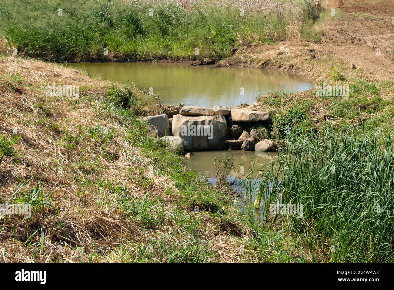 The small reservoir is blocked by the large rock for storage of the ...