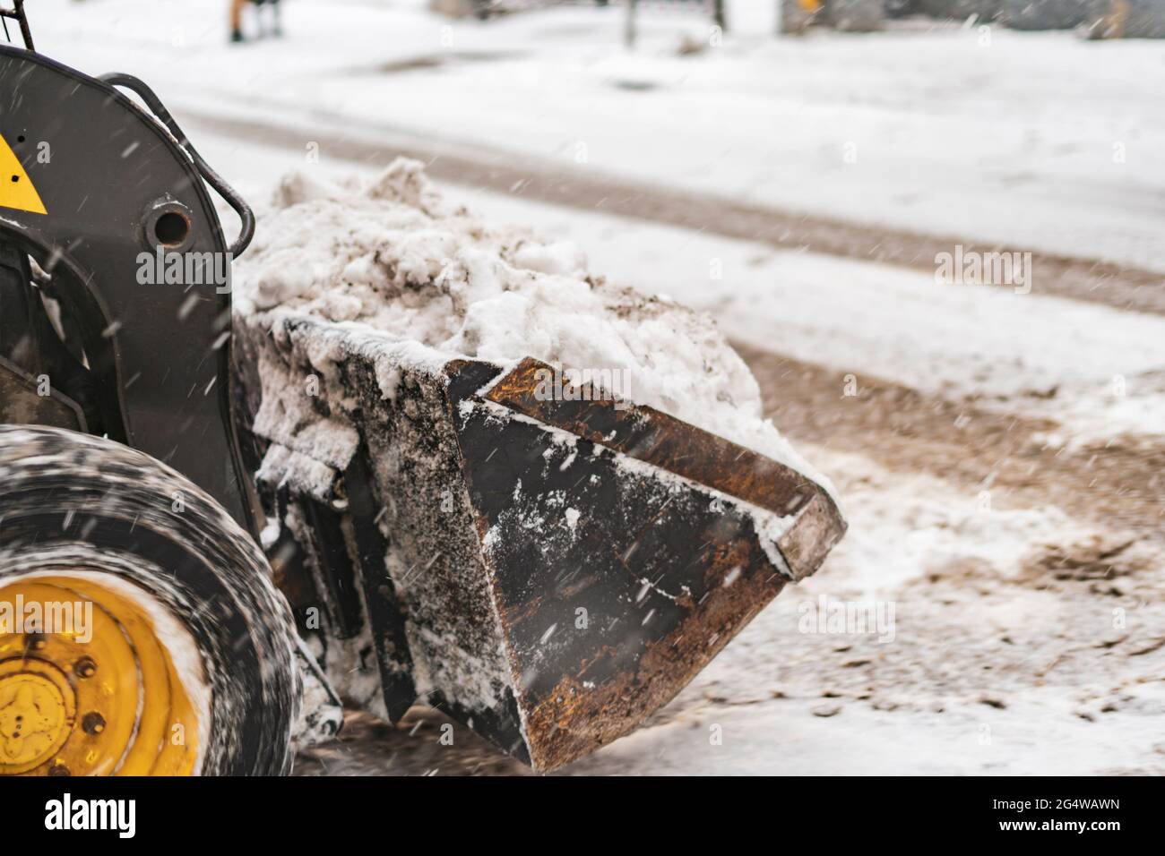 snow cleaning machine work hard in city streets Stock Photo - Alamy