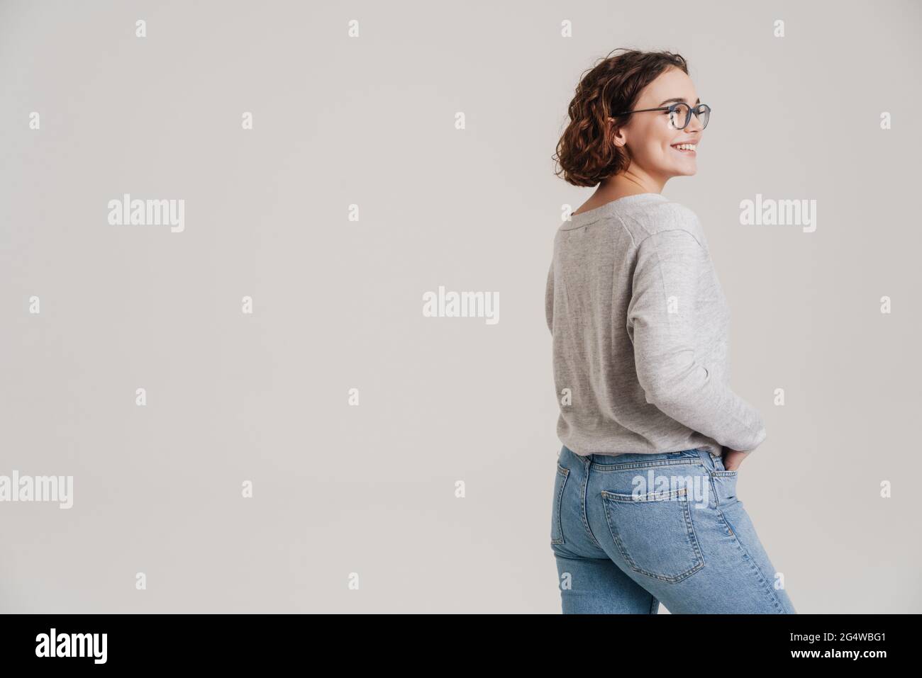 Portrait of a lovely young attractive smiling woman in casual wear ...