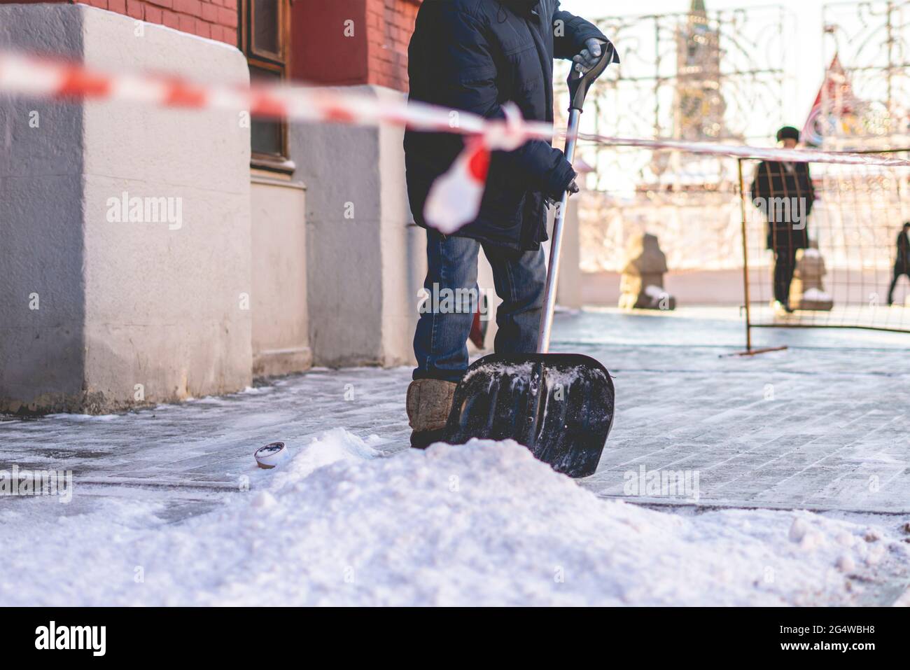 adult man shoveling snow from city streets Stock Photo - Alamy