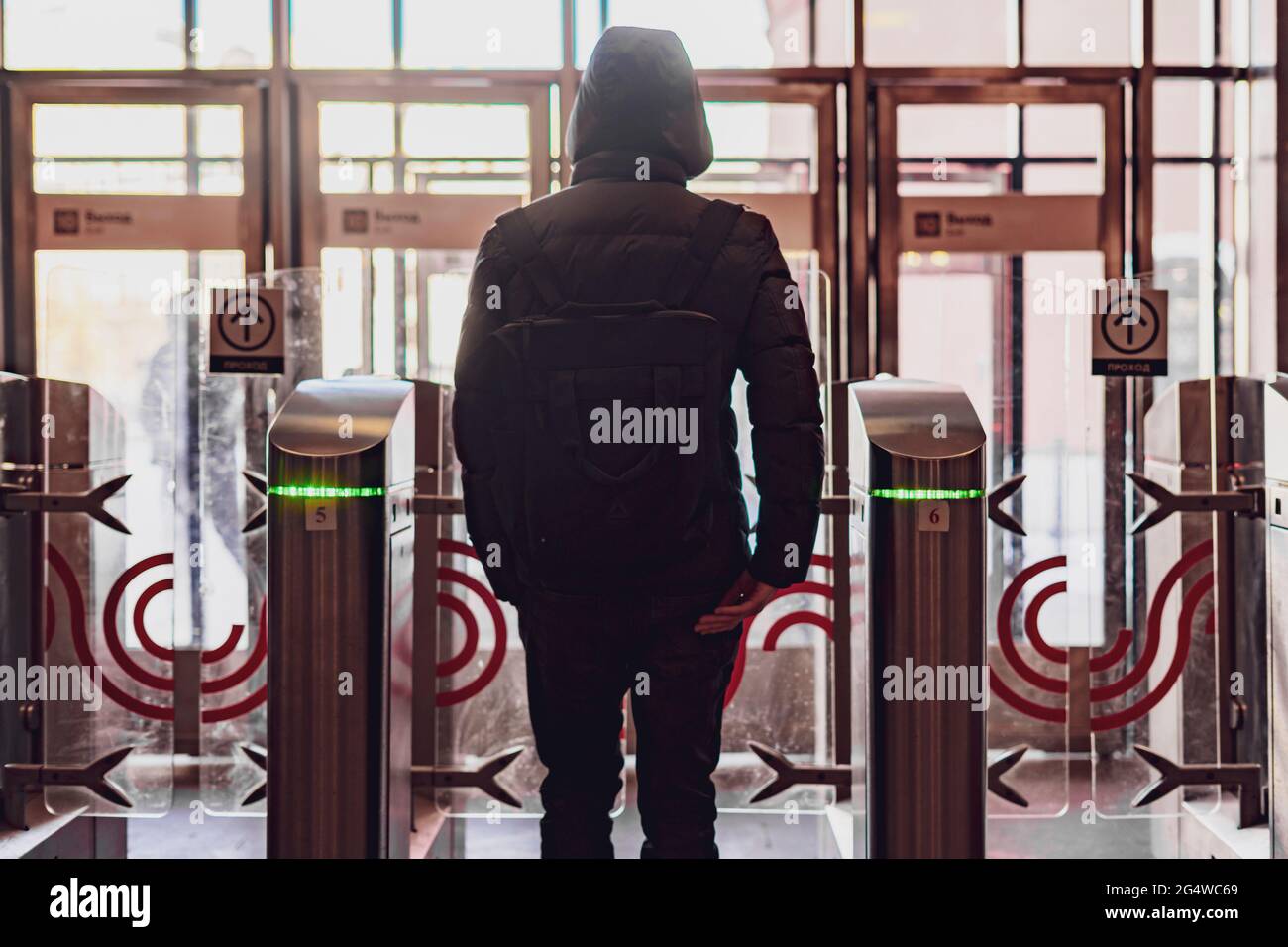 rear portrait of person go through security turnstile Stock Photo - Alamy