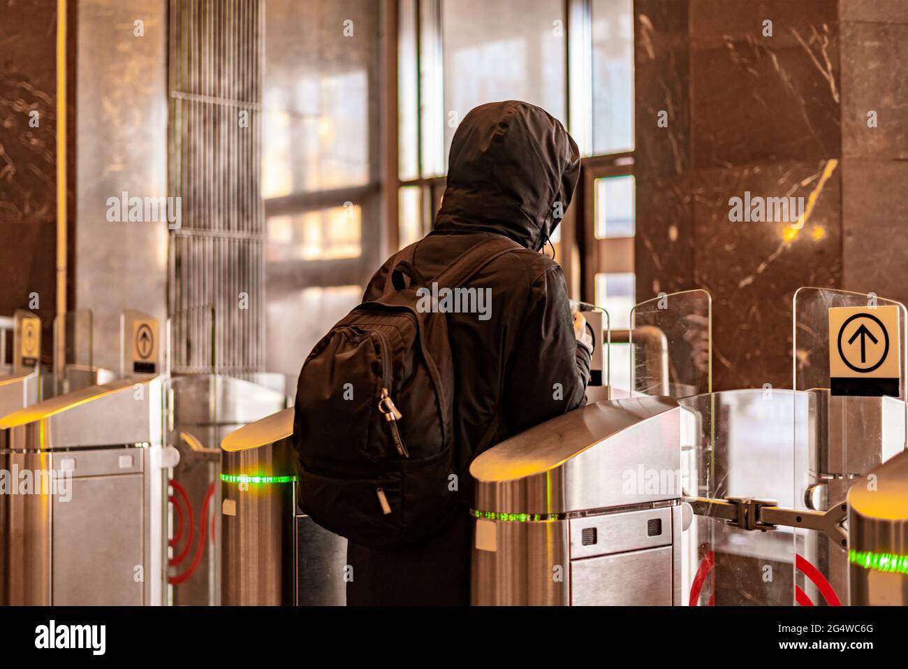rear portrait of person go through security turnstile Stock Photo - Alamy