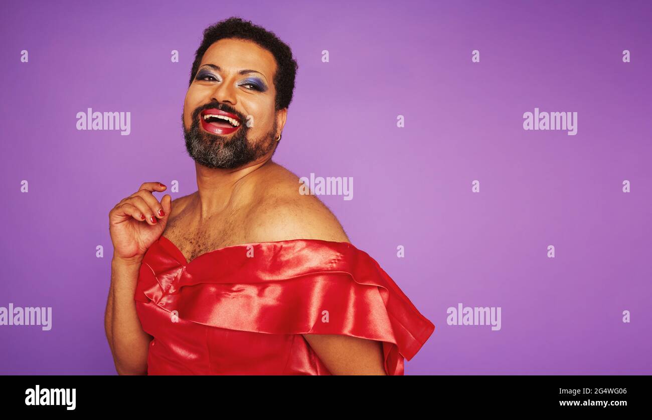 Portrait of a genderqueer in shiny female outfit. Drag queen in ...