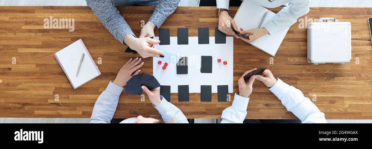 Group of people sitting at table and playing board games top view Stock ...