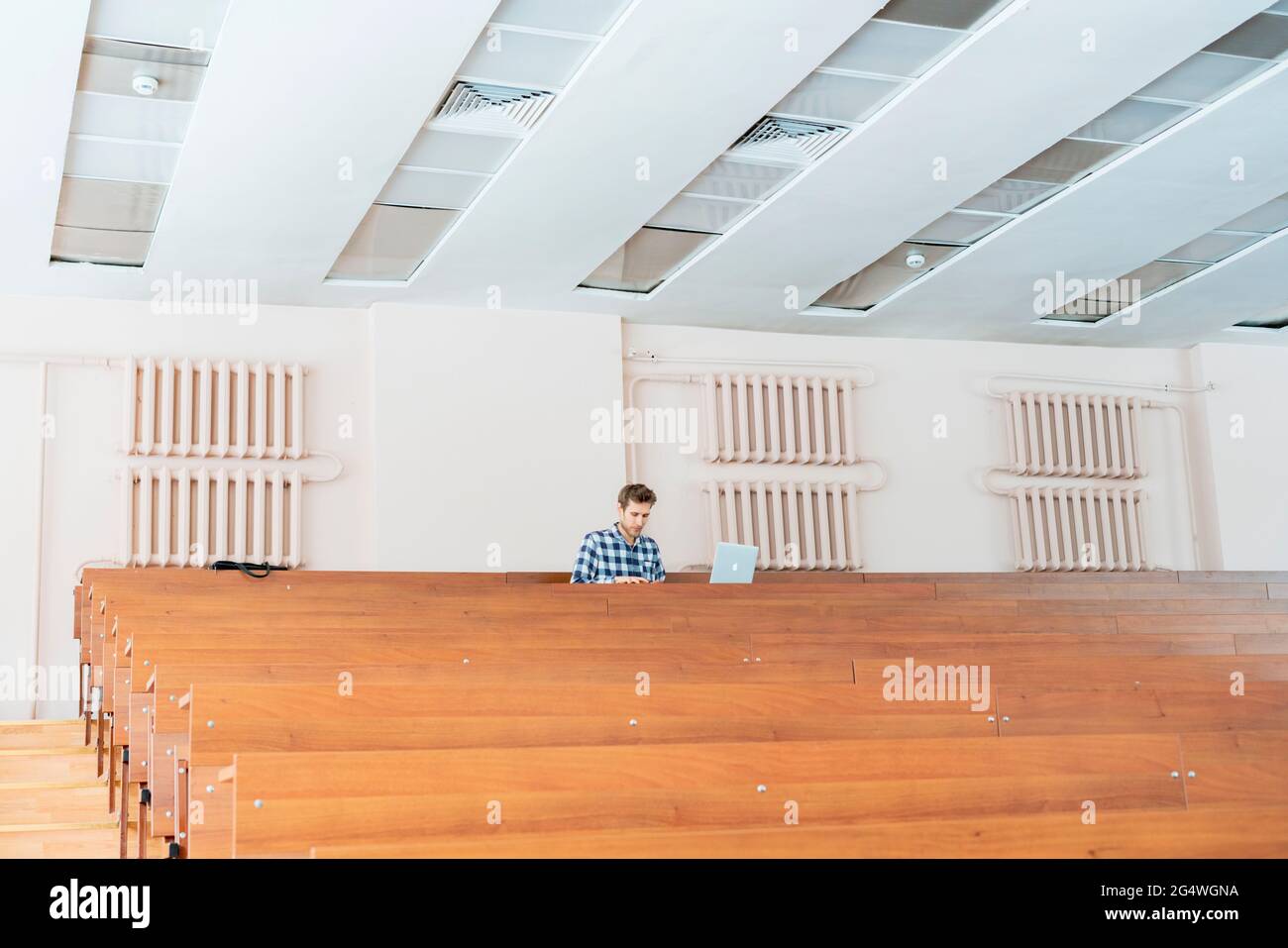 young student sit alone in huge lecture hall Stock Photo - Alamy