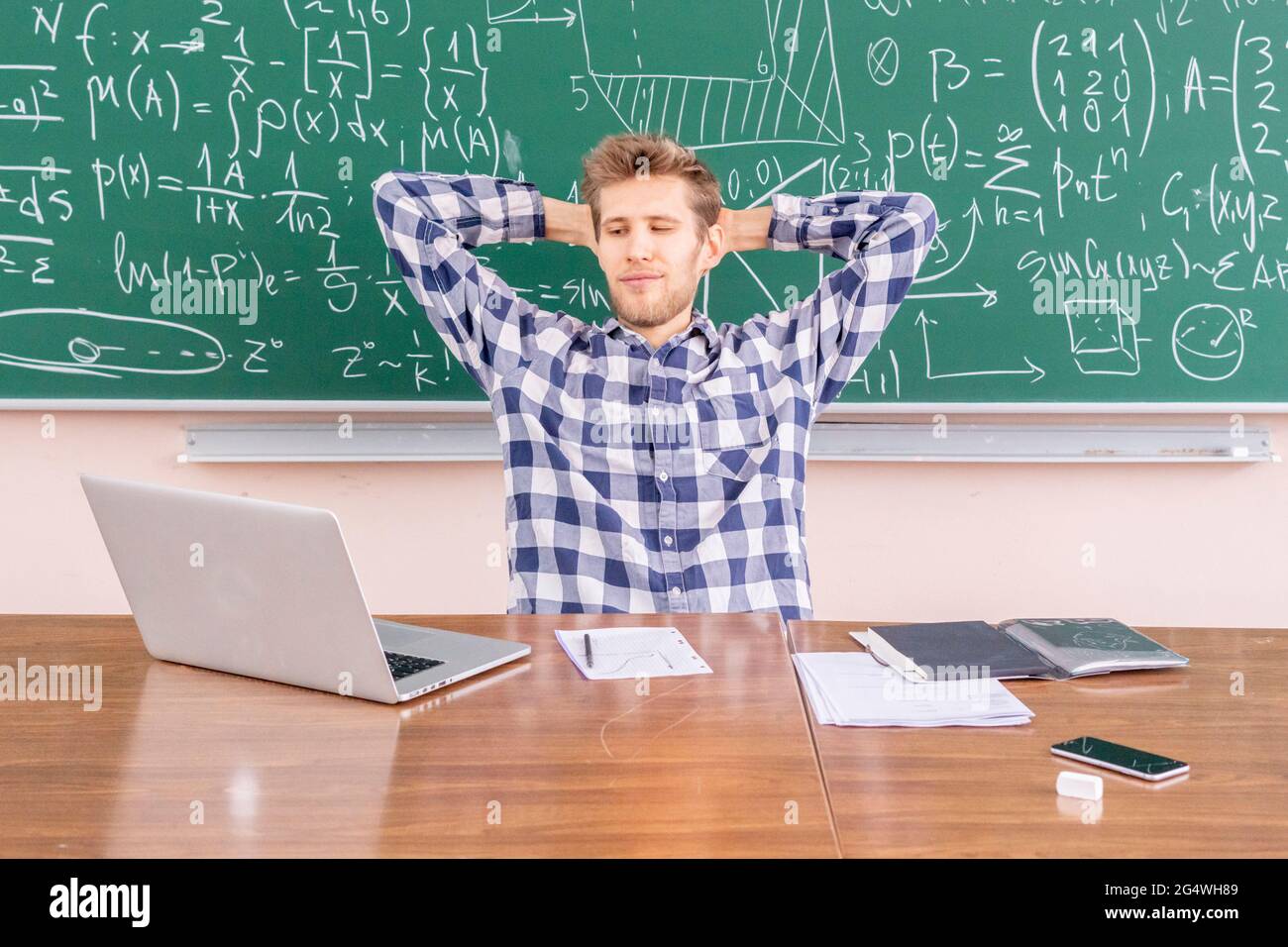 young happy scientist sitting in front of blackboard Stock Photo - Alamy young happy scientist sitting in front of blackboard Stock Photo - Alamy