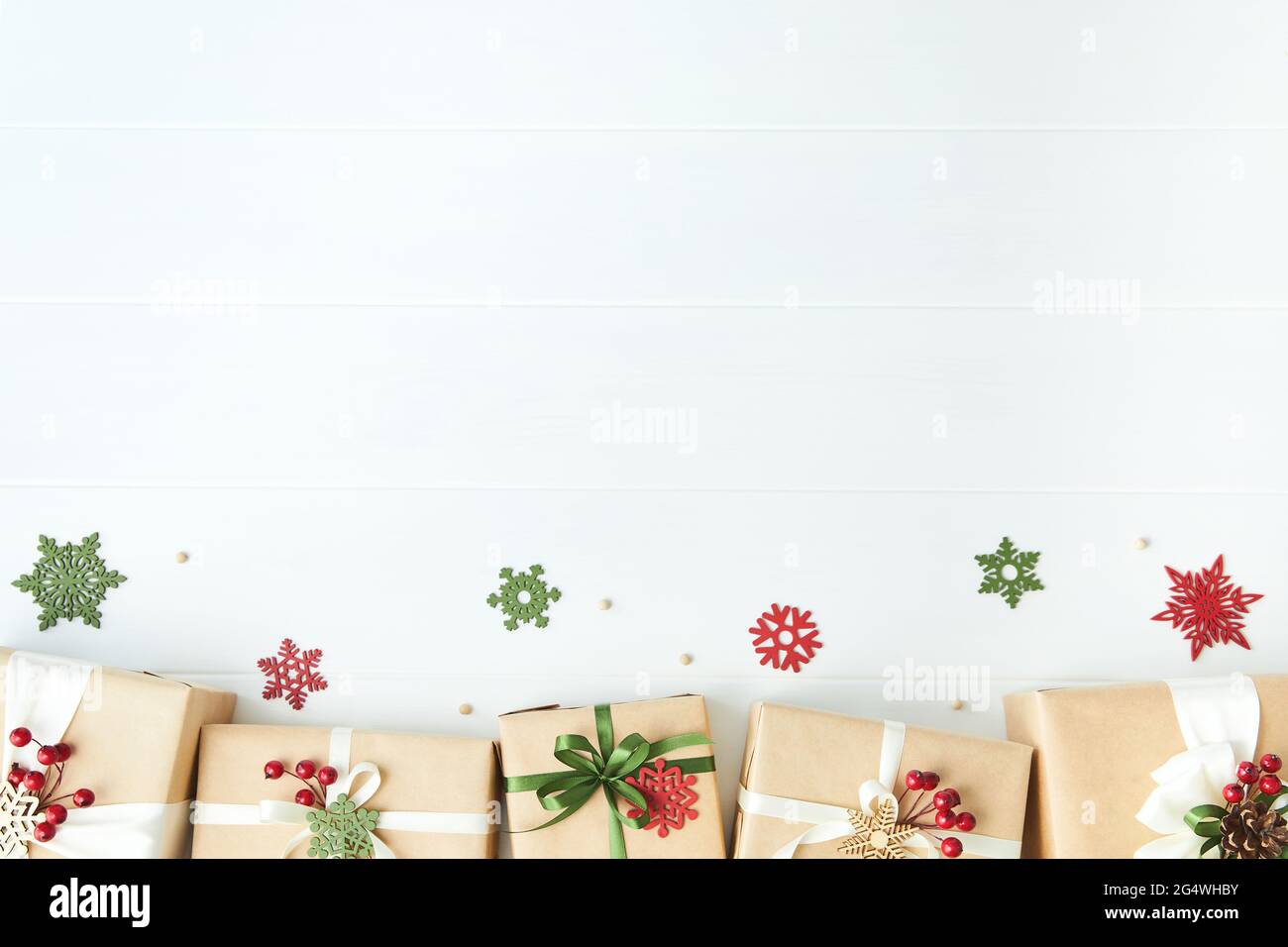 Border of gift boxes wrapped in kraft paper on white wood desk ...