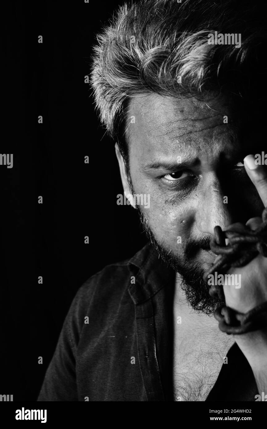 Black and white portrait of a South Asian man posing for a picture ...