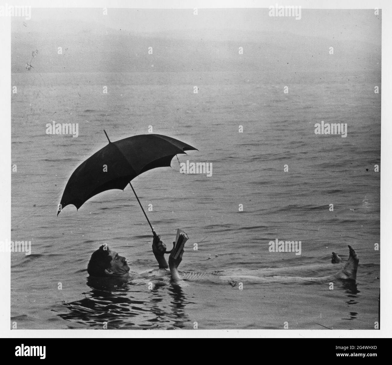 Man Floating and Reading in the Dead Sea, 1920 Stock Photo - Alamy