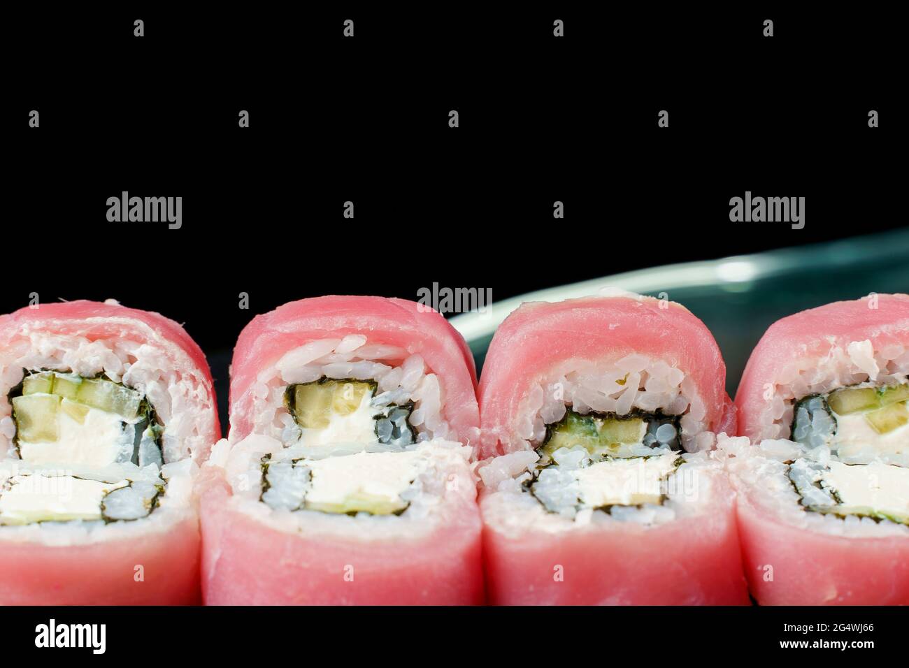Rolls with tuna, avocado, cucumber, cream cheese, nori close-up ...