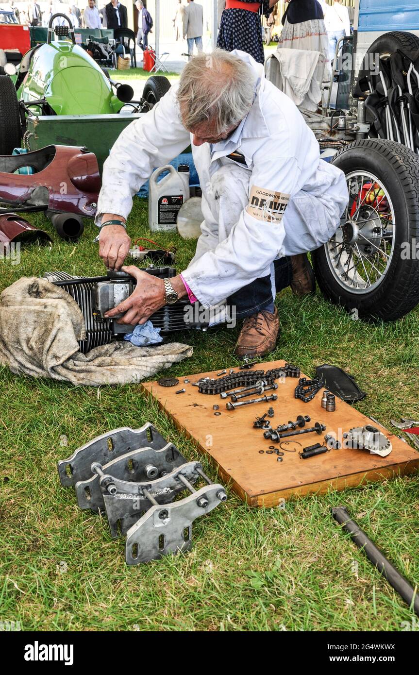 Race mechanic with a stripped down engine at the Goodwood Revival 2011 ...