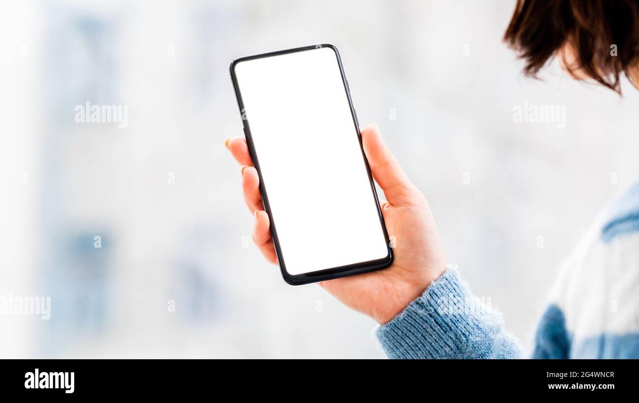 Hand holding mobile phone with white screen Stock Photo - Alamy
