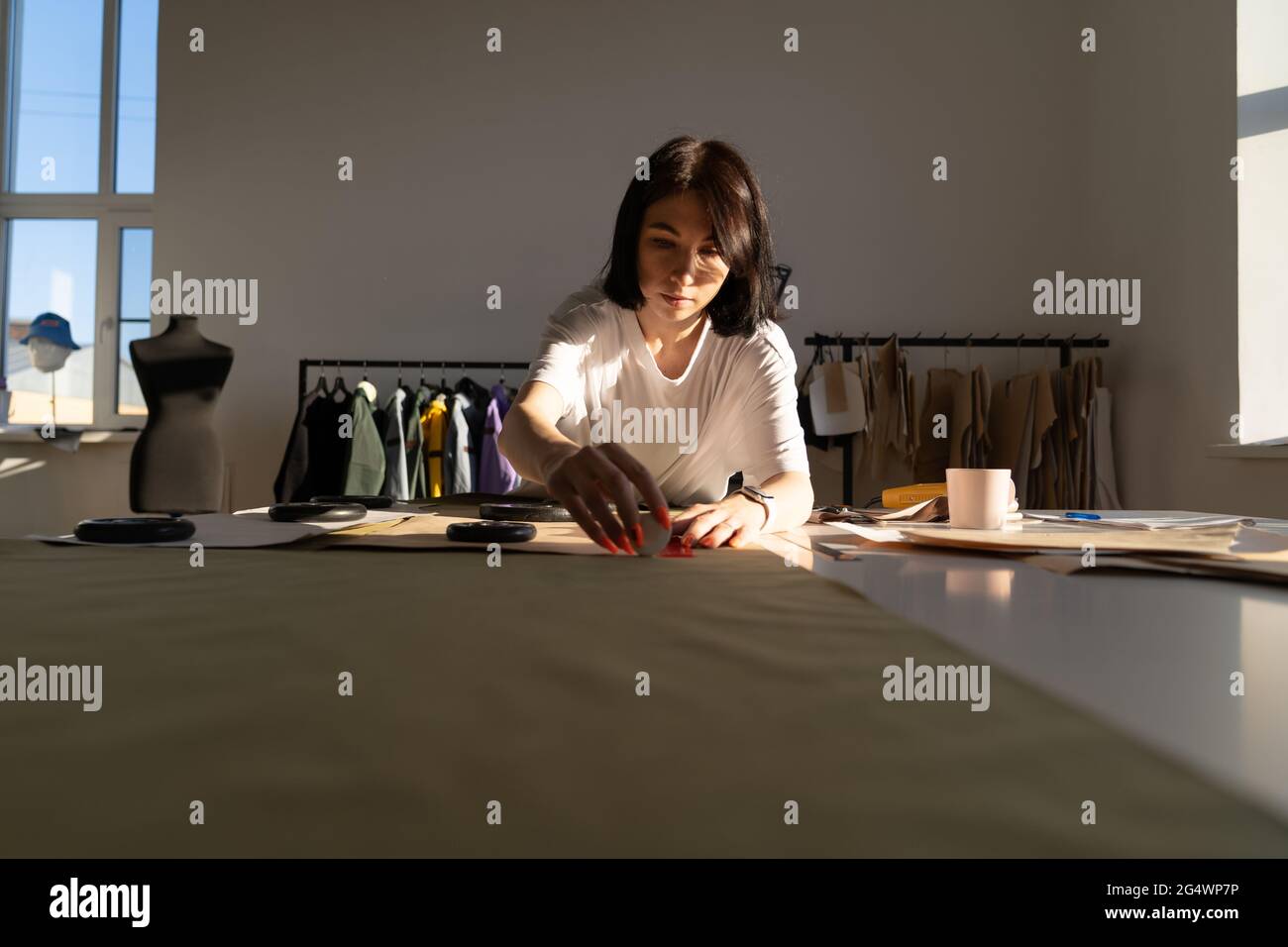 Professional sewer work with pattern, fabric. Design studio owner ...