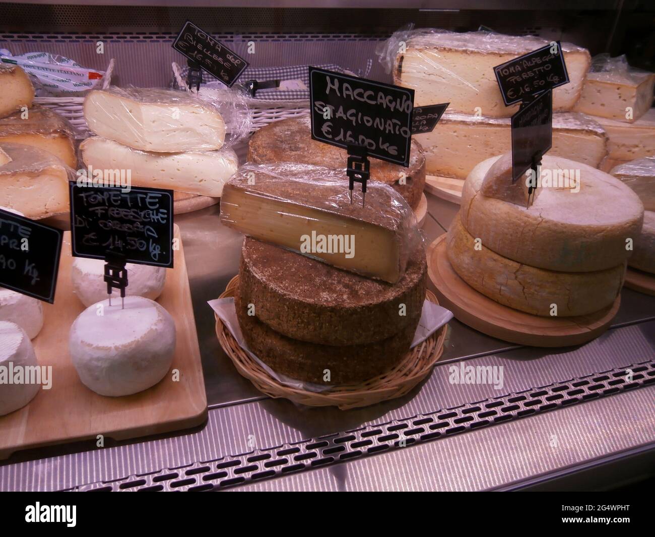 showcase of alpine artisan cheeses in an Italian small shop Stock Photo ...