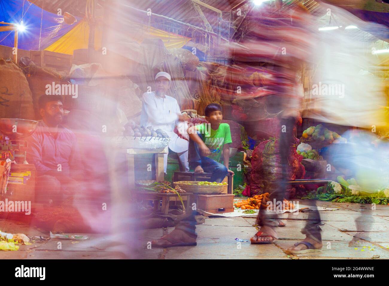 Muslim traders at indoor night market selling vegetables with public ...