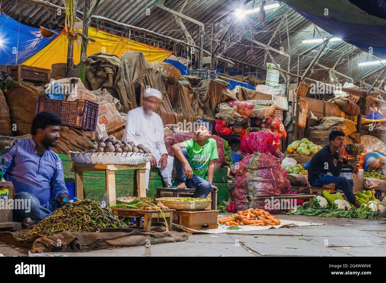 Muslim traders at indoor night market selling vegetables, Mysore ...