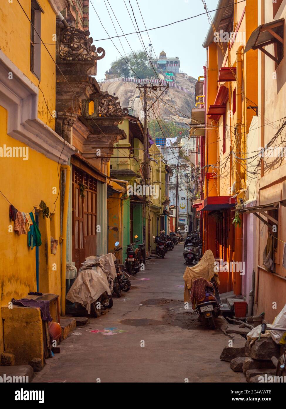 Narrow street with colourful houses leading uphill to Rockfort Temple ...