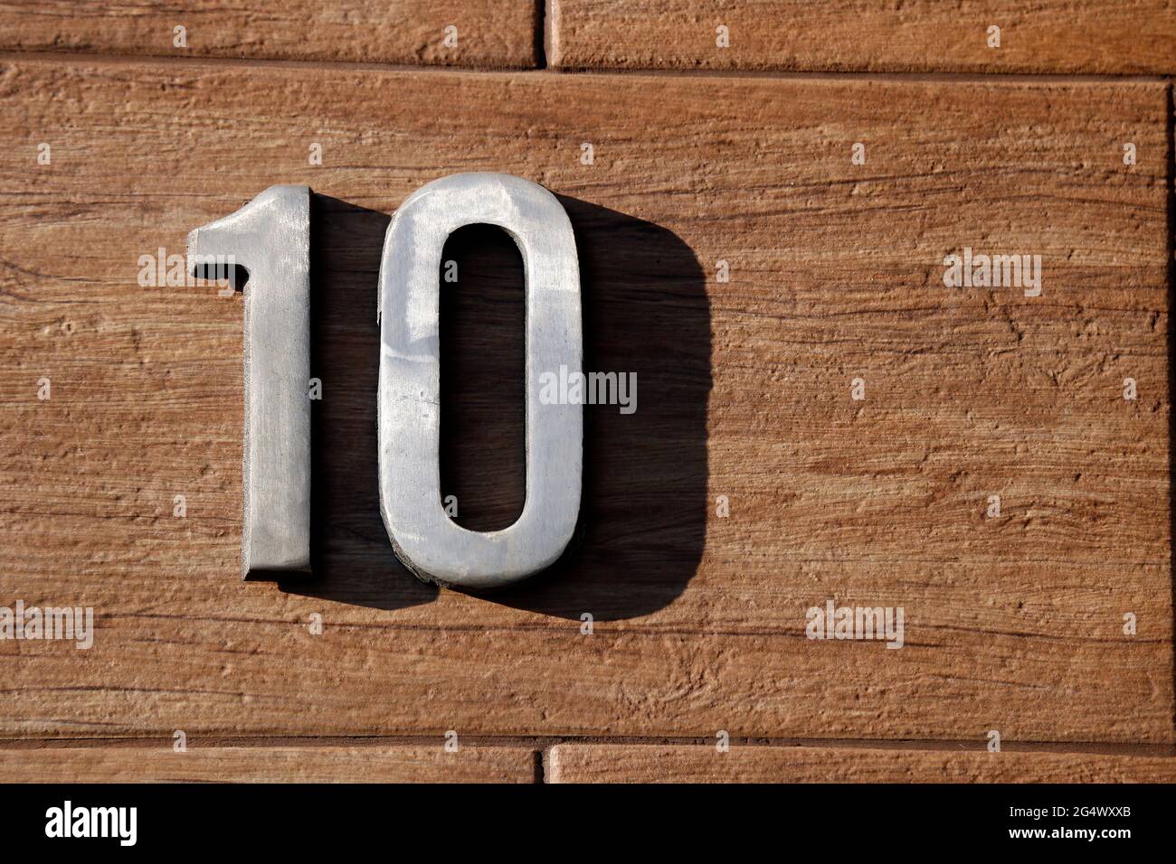 number ten in metal material with shadow, fixed in texture and copy ...