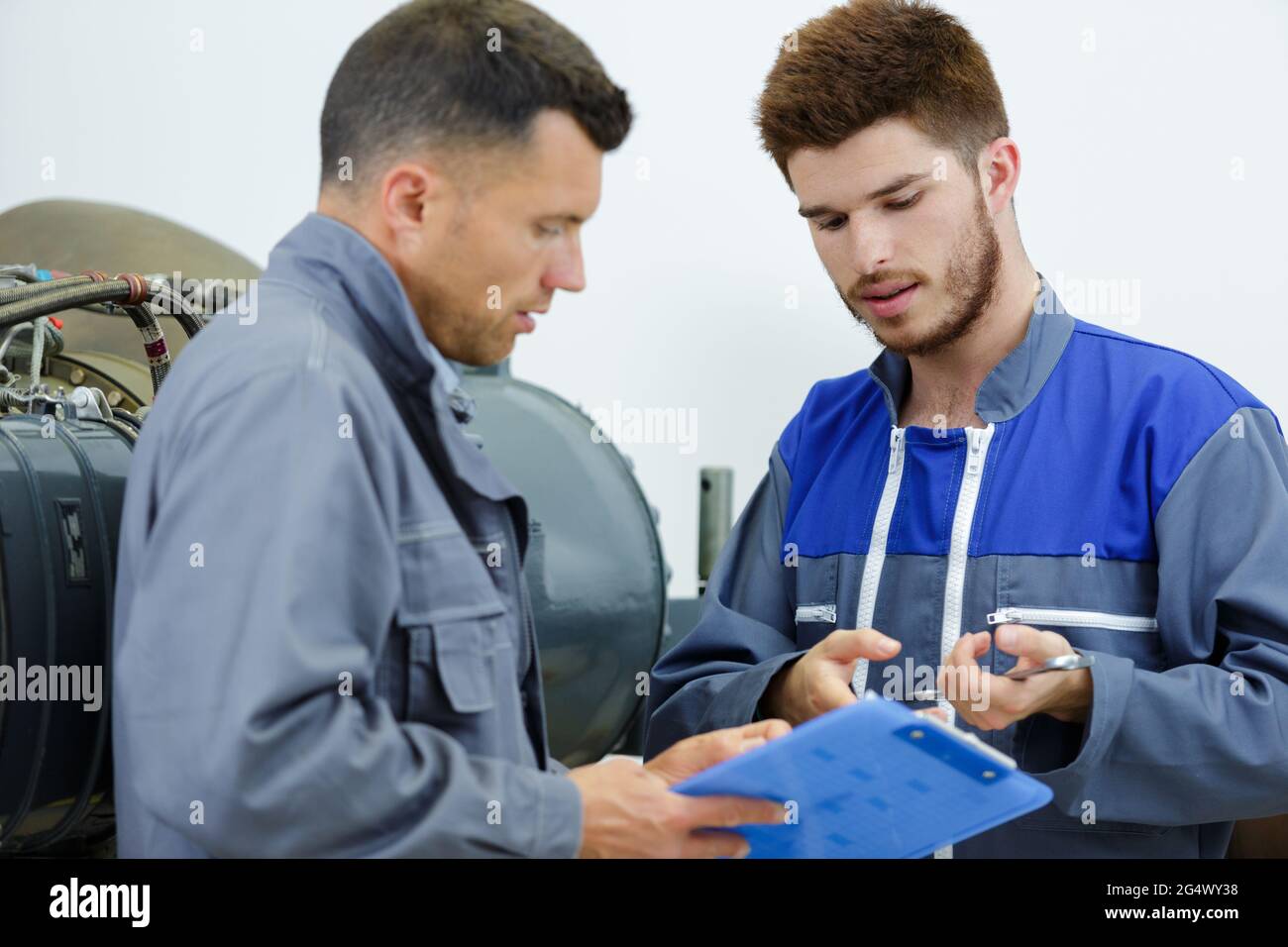 two automobile mechanics checking checklist Stock Photo - Alamy
