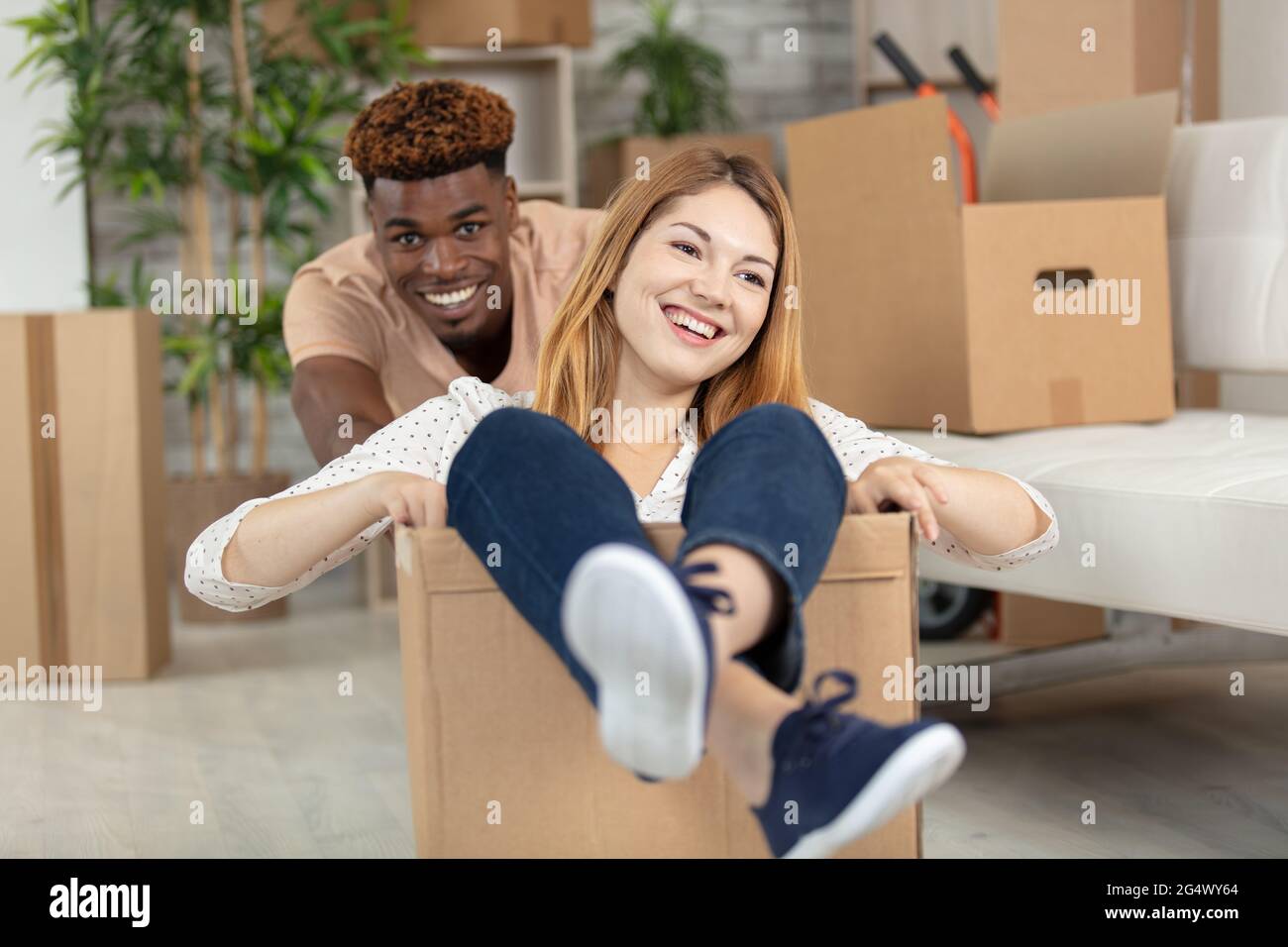 beautiful couple playing with boxes Stock Photo - Alamy