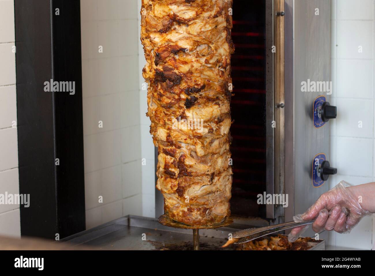 Meat on a spit. Shaurma is getting ready in a coffee shop. The chicken ...