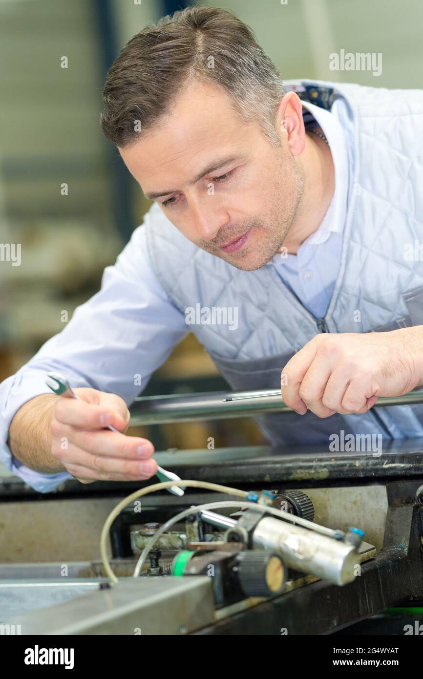 man fixing the electronics of a factory Stock Photo - Alamy