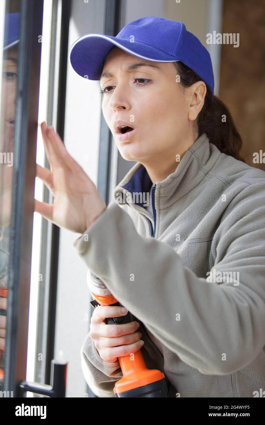 woman wearing helmet using power drill Stock Photo - Alamy
