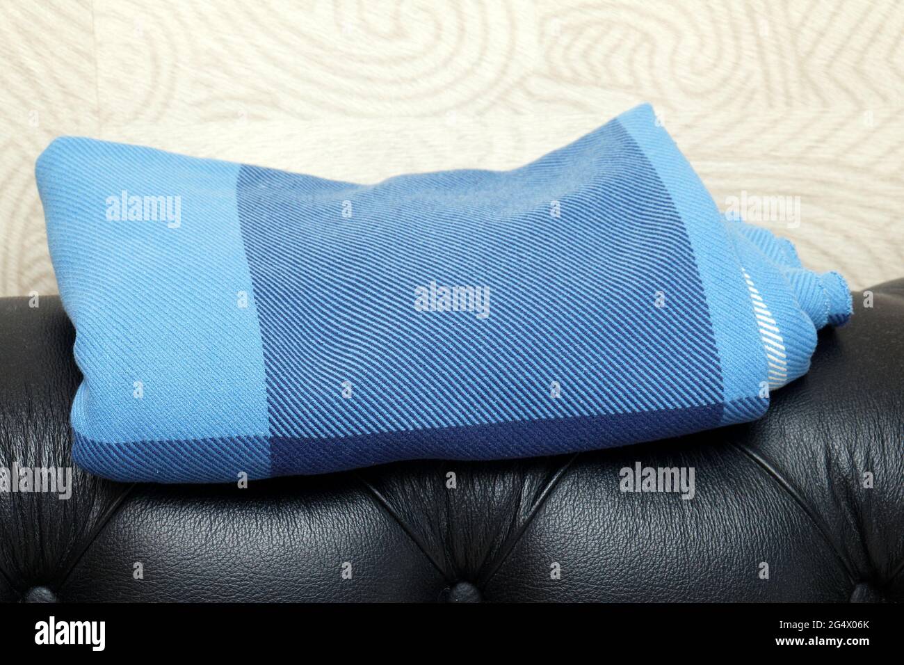 Soft blue blanket on top of sofa bed Stock Photo - Alamy