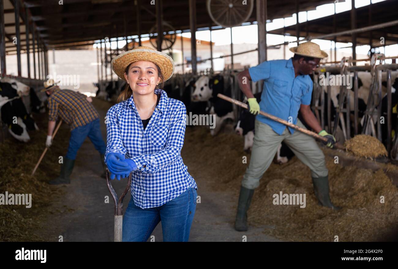 Female farmer posing in cowshed at farm Stock Photo - Alamy