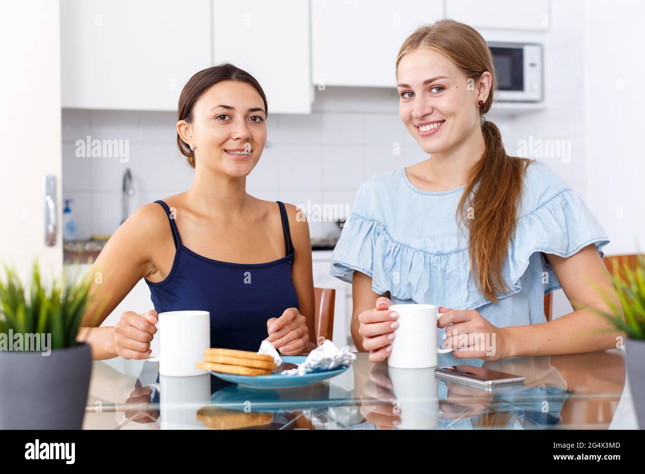 Portrait of two young friendly women Stock Photo - Alamy