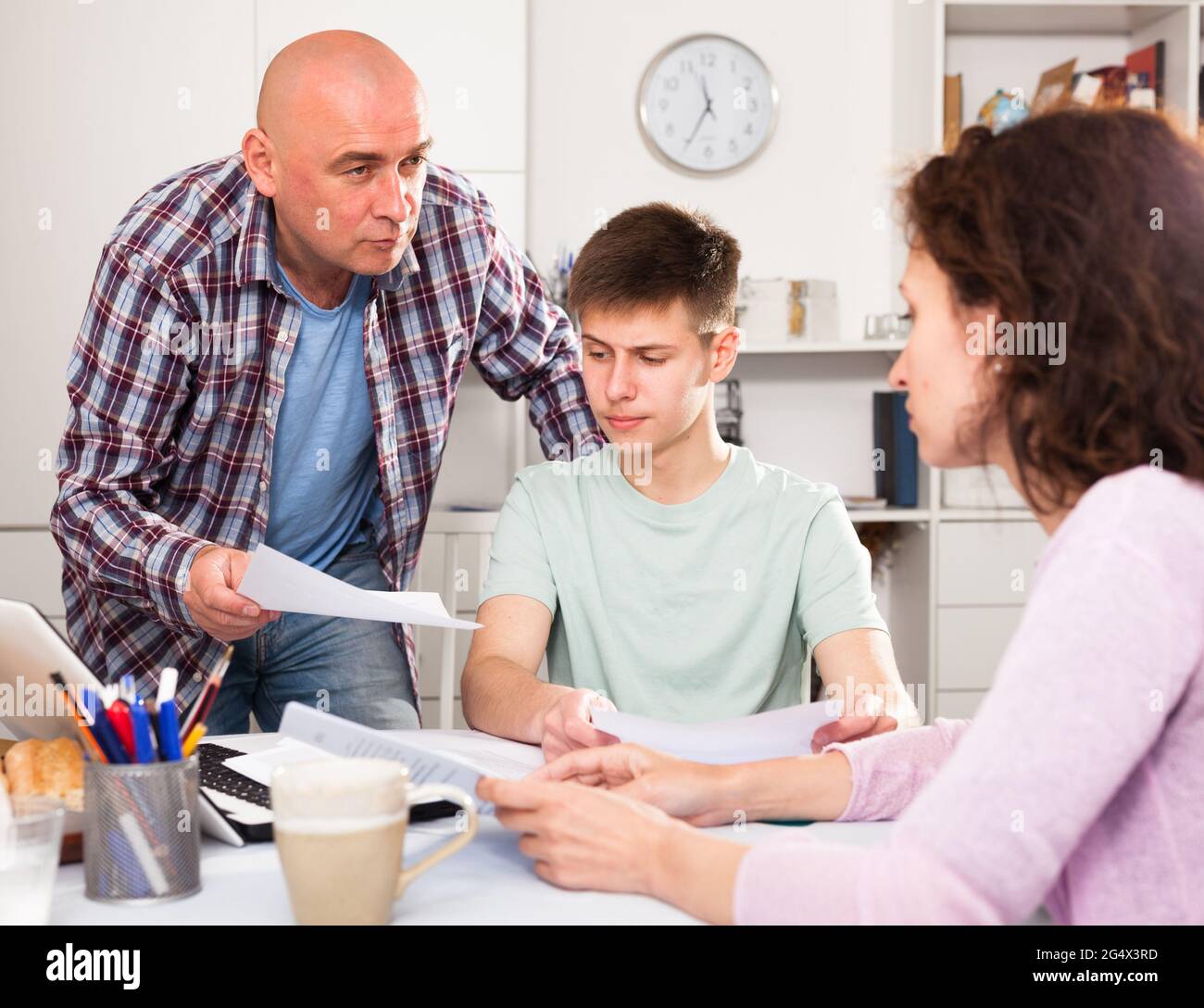 Family with son working with papers Stock Photo - Alamy