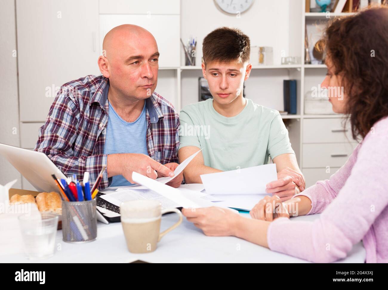 Family calculating domestic budget Stock Photo - Alamy