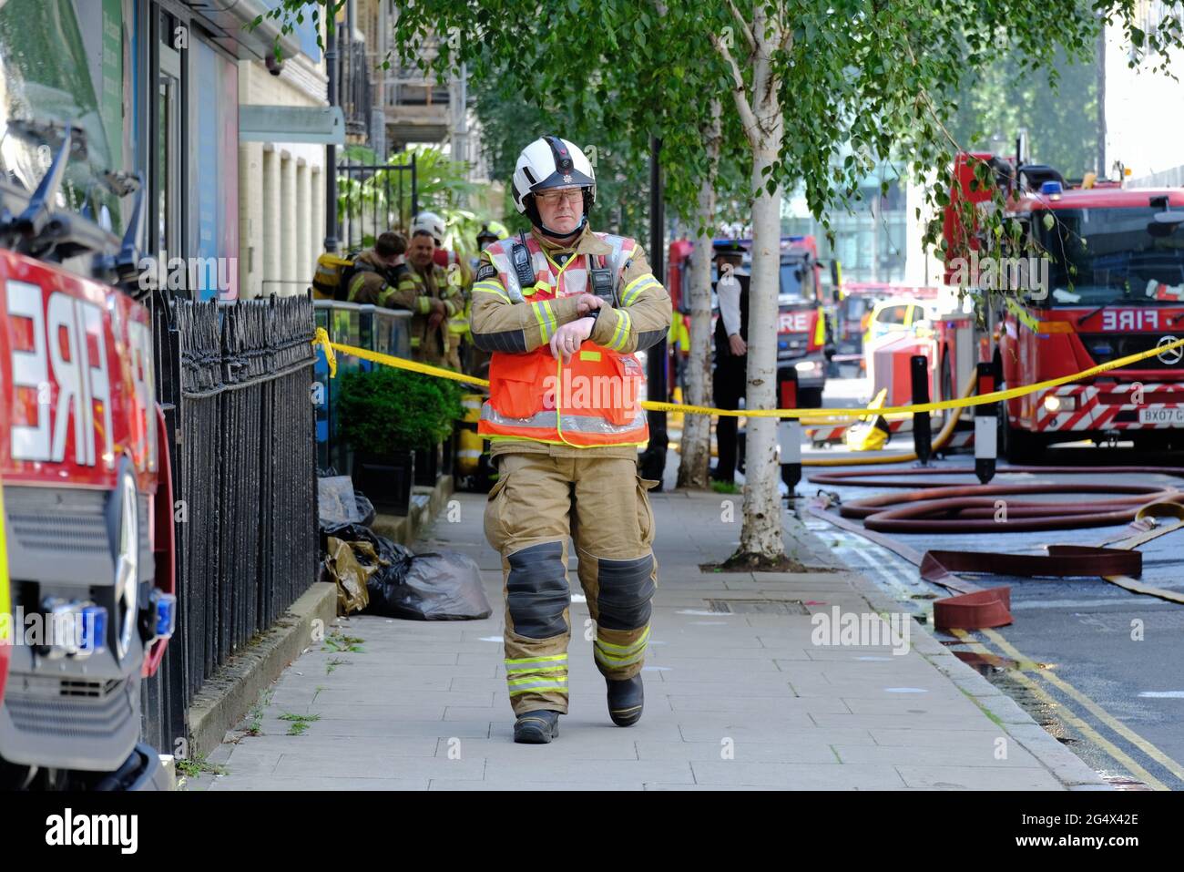 A firefighter leaves the cordoned-off area outside the Lore of the Land ...