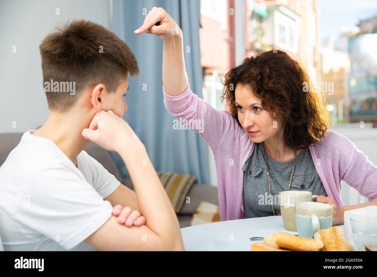 Mother reprimanding teenage son Stock Photo - Alamy