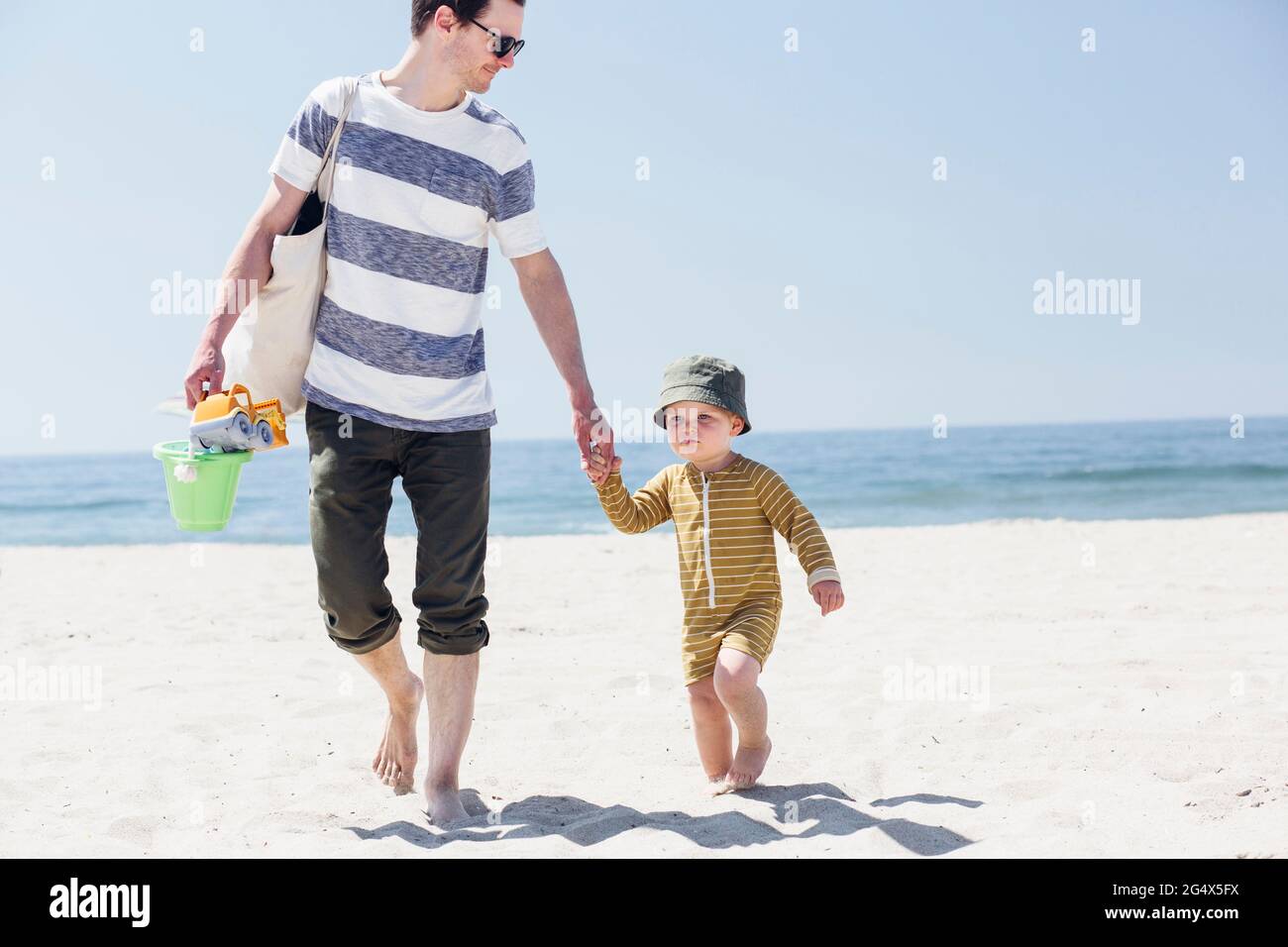 Walking holding sunglasses childhood hi-res stock photography and ...