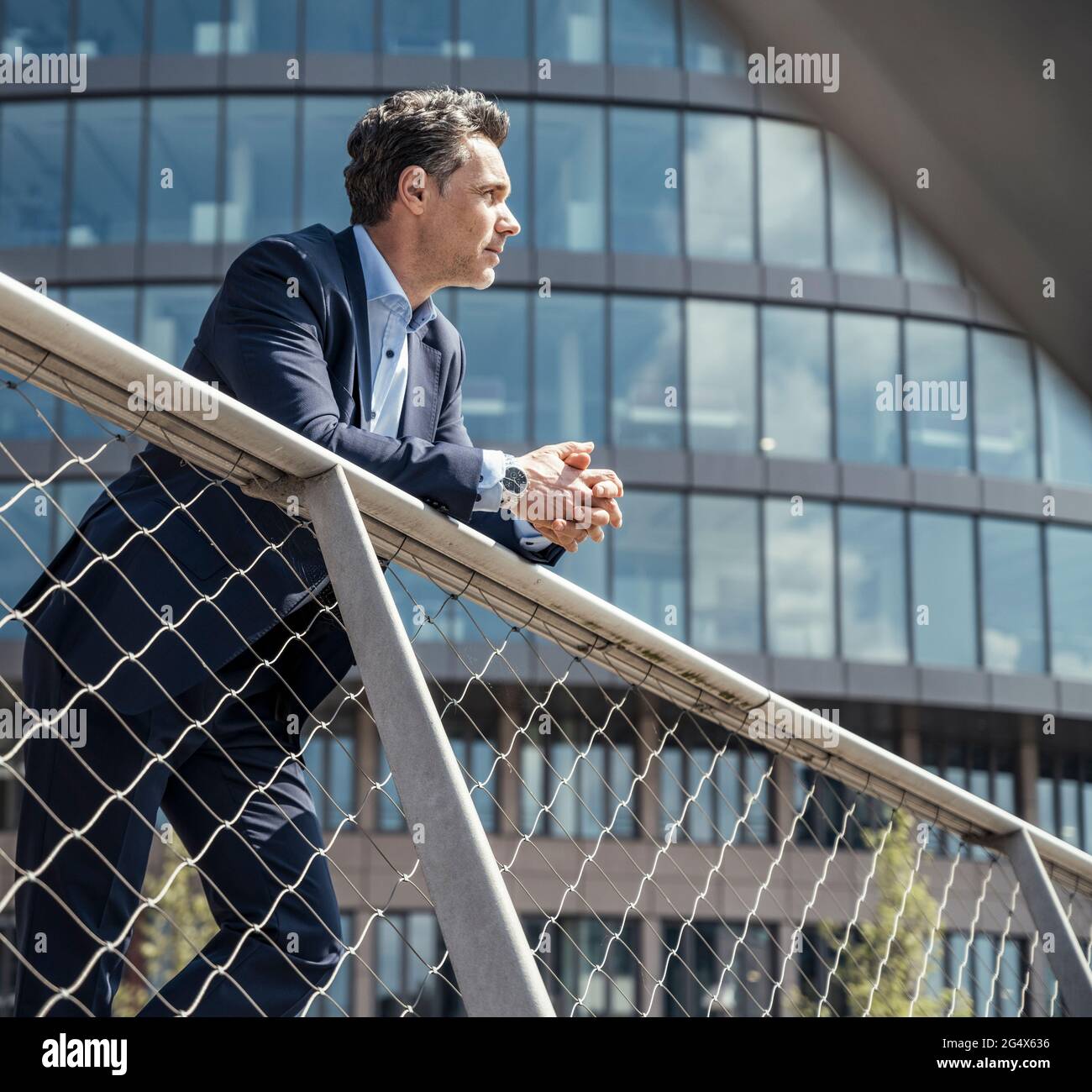 Pensive businessman leaning on railing hi-res stock photography and ...