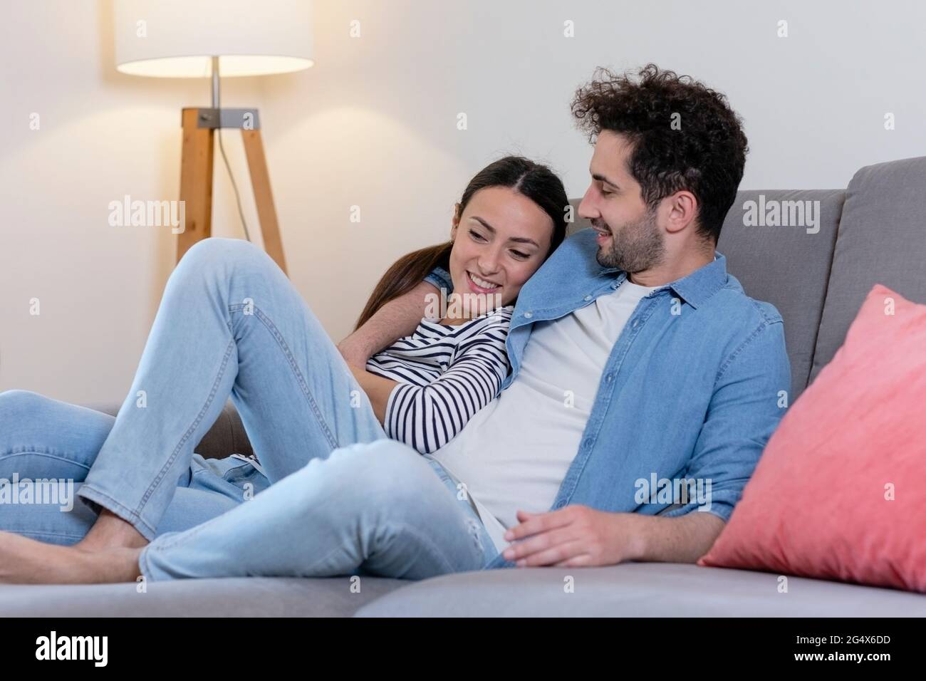 Couple sitting together on sofa hi-res stock photography and images - Alamy