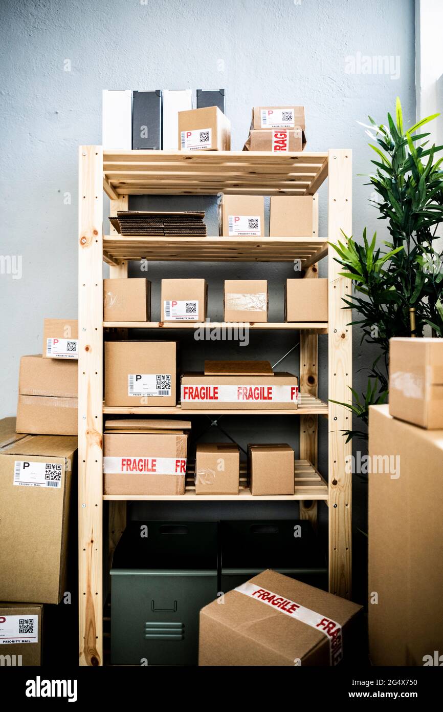 Packages on rack at distribution warehouse Stock Photo - Alamy
