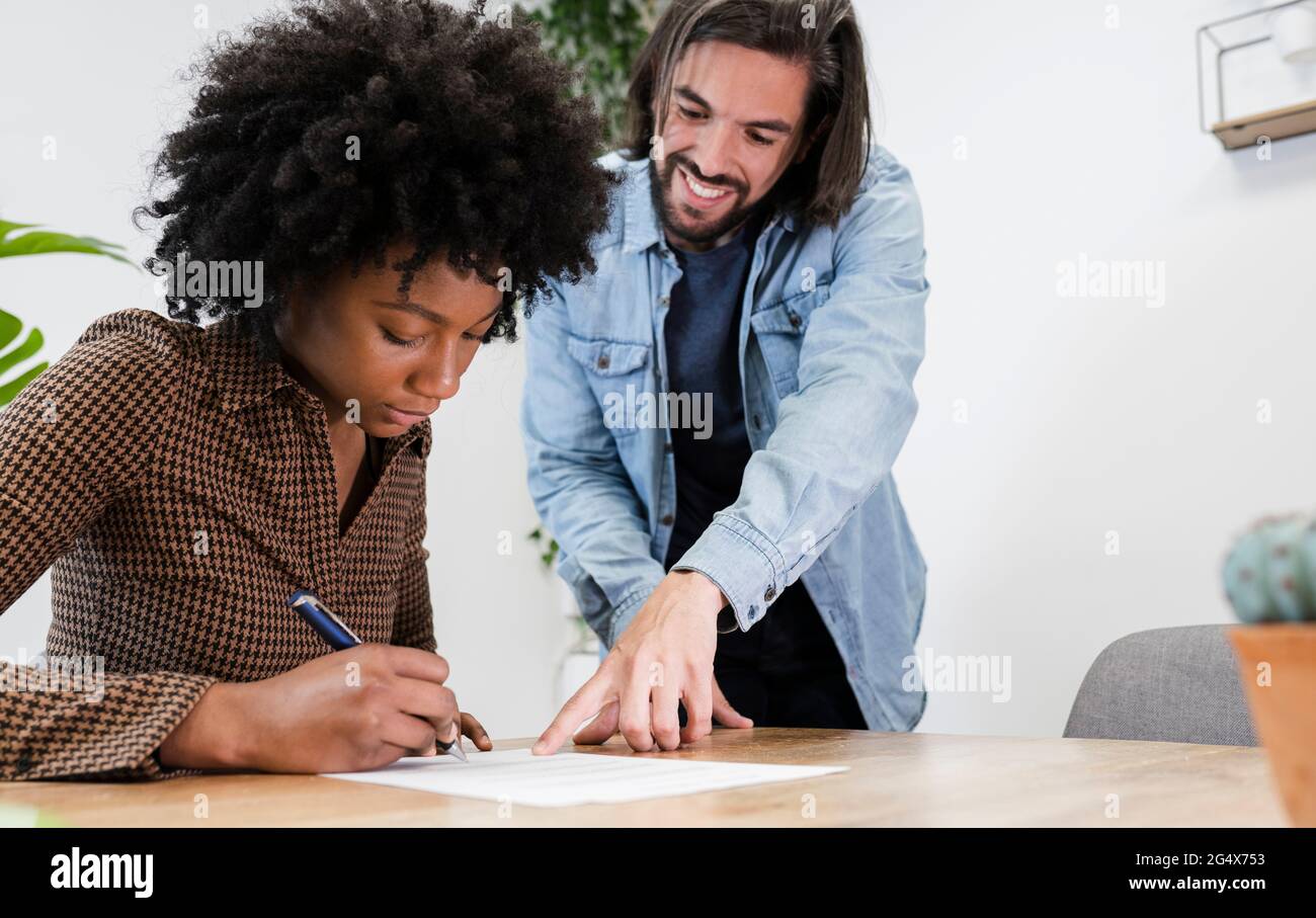 Standing african businessman guiding female hi-res stock photography ...