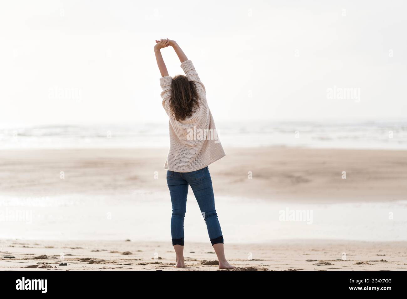Woman arms raised rear view hi-res stock photography and images - Alamy