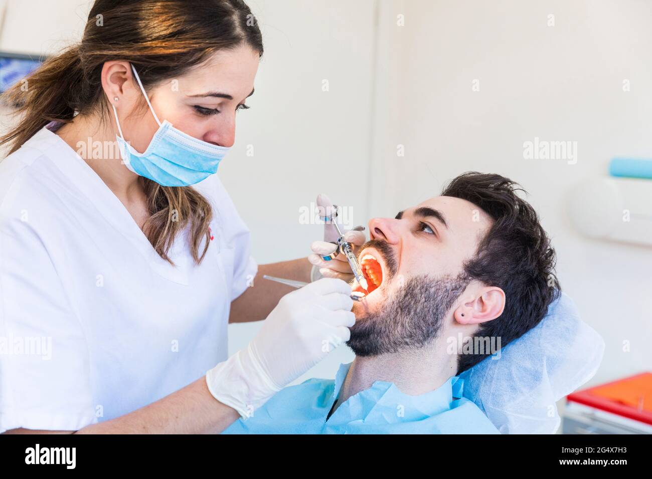 Female dentist wearing face mask hi-res stock photography and images ...