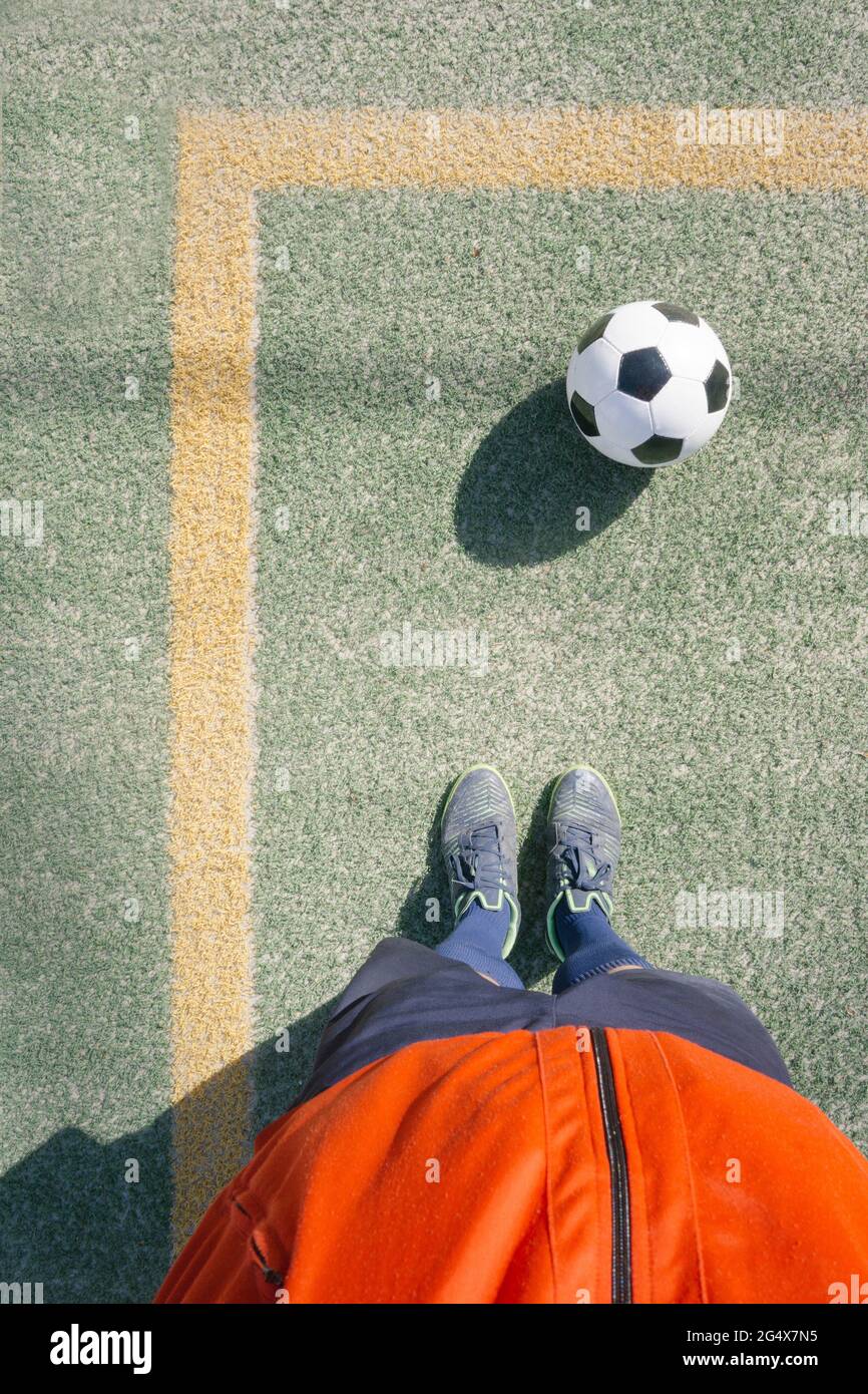 Man standing in front of soccer ball on field Stock Photo - Alamy