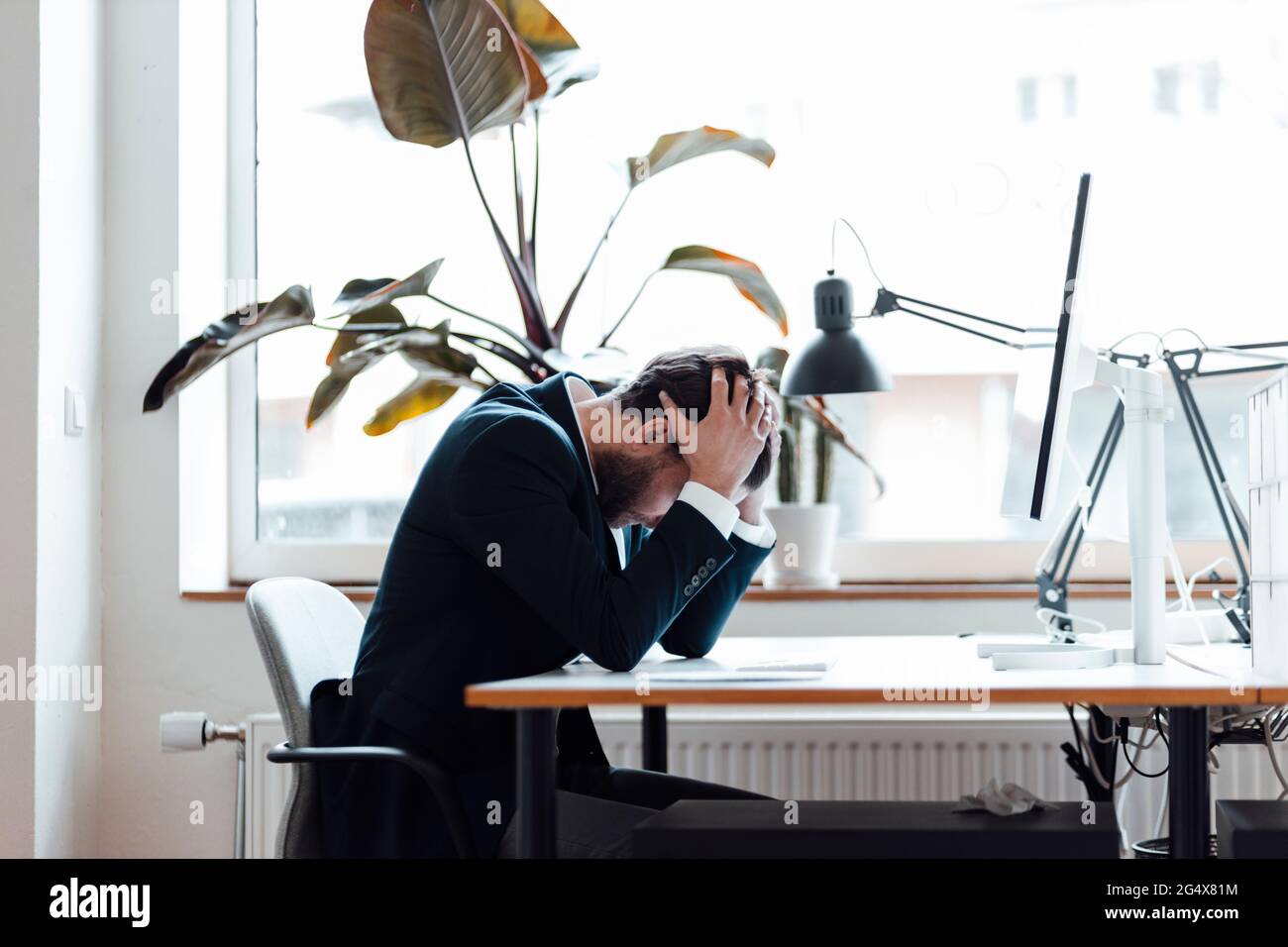 Head in hands desk hi-res stock photography and images - Alamy
