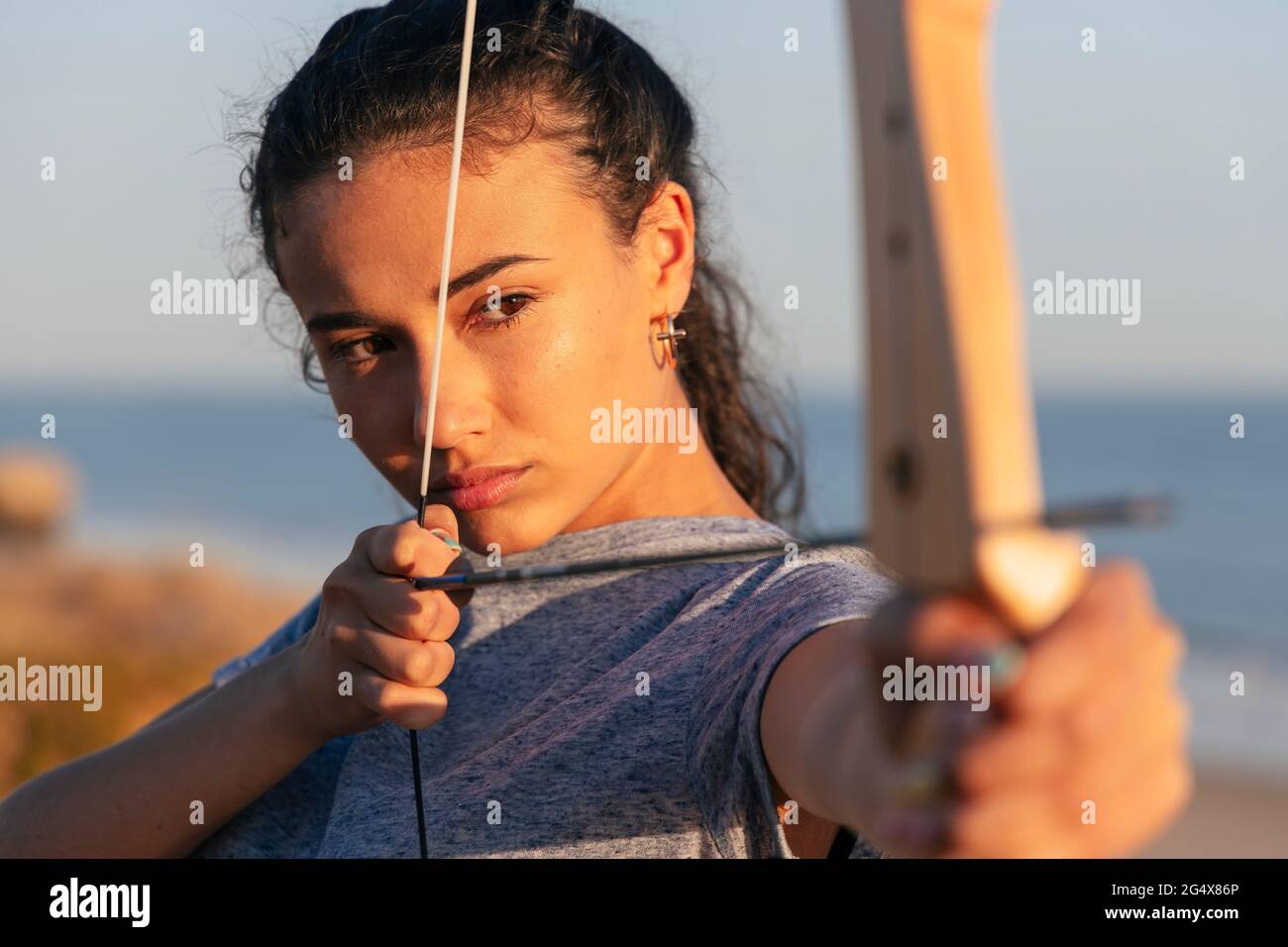 Beautiful woman aiming bow arrow hi-res stock photography and images ...