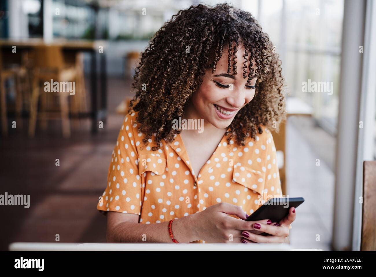 Young smiling woman texting hi-res stock photography and images - Alamy