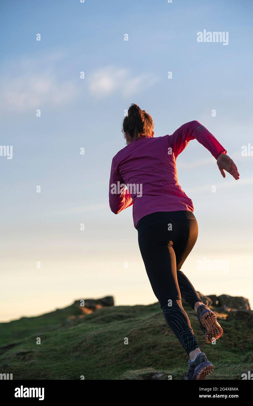Woman jogging at sunrise hi-res stock photography and images - Alamy