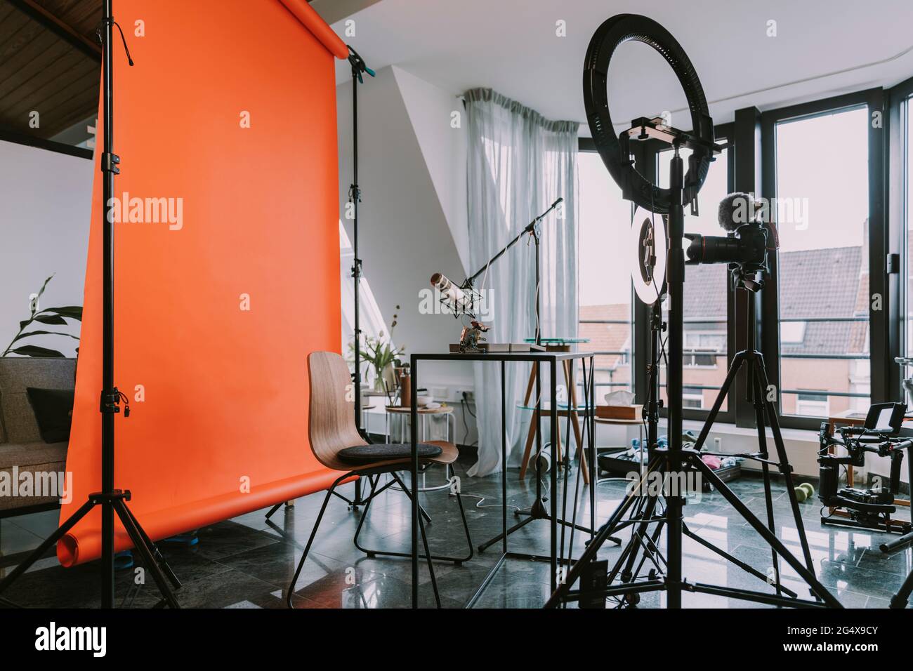 Backdrop with ring light and photographic equipment at home workshop ...